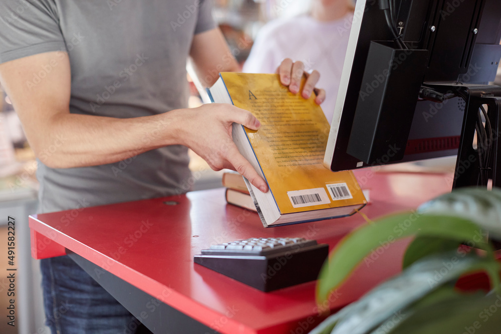 Male student scanning book in library Stock Photo | Adobe Stock