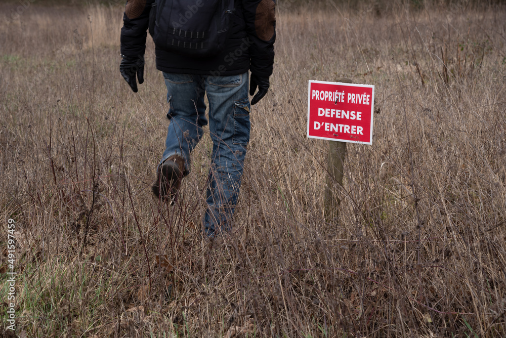 Man does not respect No entry sign for private property (propriété ...