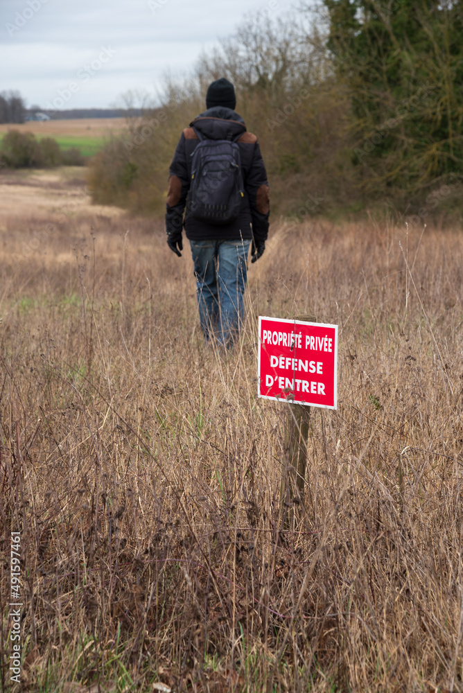 Man does not respect No entry sign for private property (propriété ...