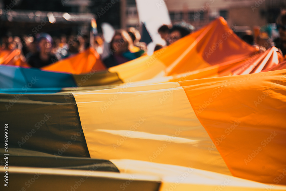 people holding giant rainbow flag at pride parade - LGBT symbol Stock ...