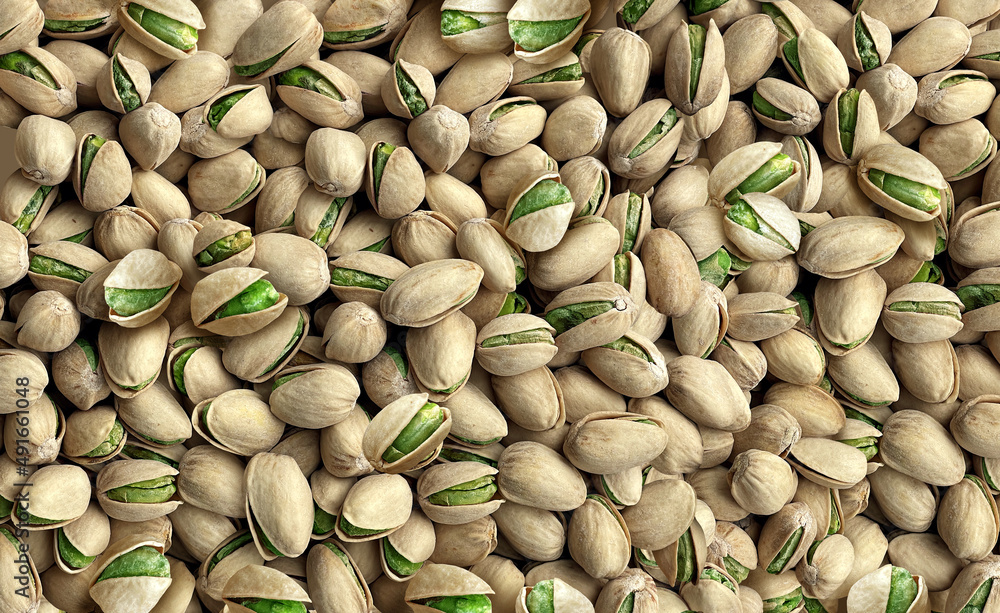 Pistachio seed background as a bulk group of naturally opened seeds ...