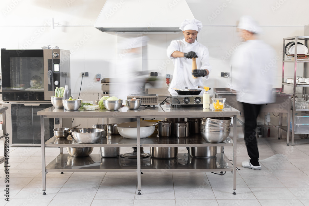 Chef cooks working in professional kitchen. Chefs hurry up, actively ...