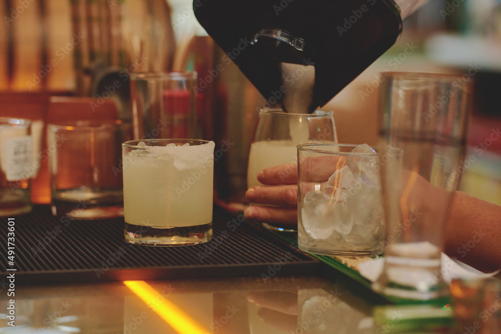 Female barman preparing drinks. cocktail bar Drinks at the bar. Fresh ...