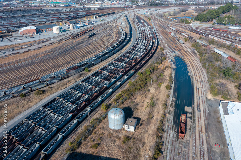 Large industrial rail yard with coal cars and empty freight train cars ...