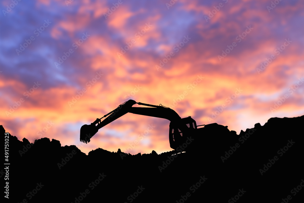 Excavators silhouette are digging soil with bucket lift up in the ...
