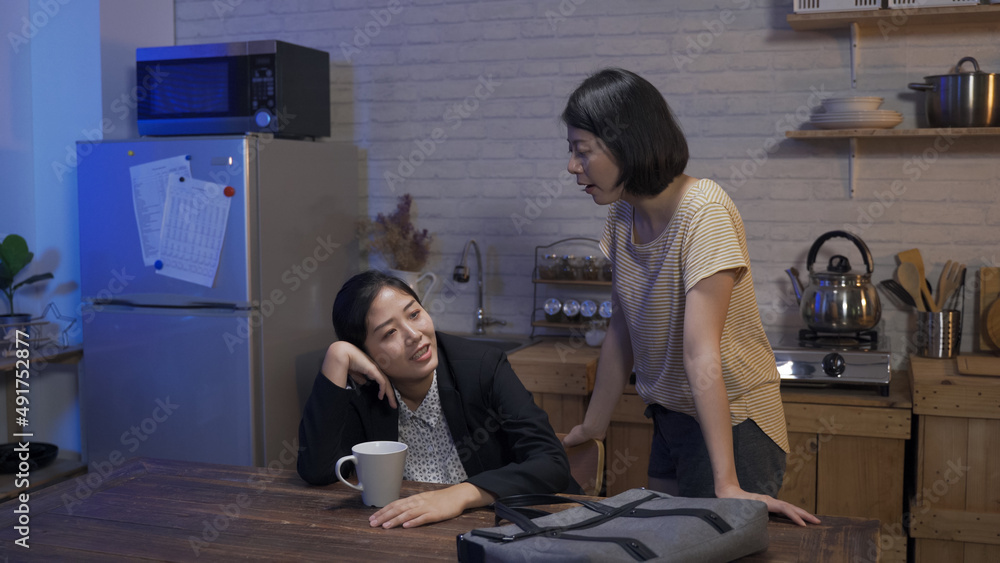tired female employee getting off work late is putting her briefcase on ...