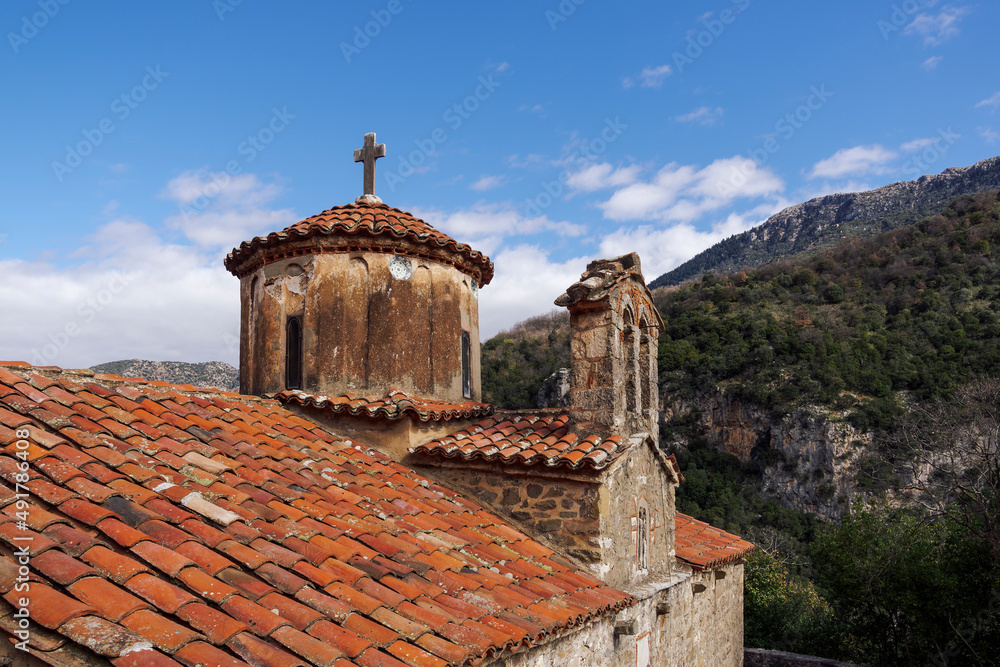Greek Orthodox Monastery with cross above dome, against blue sky with ...