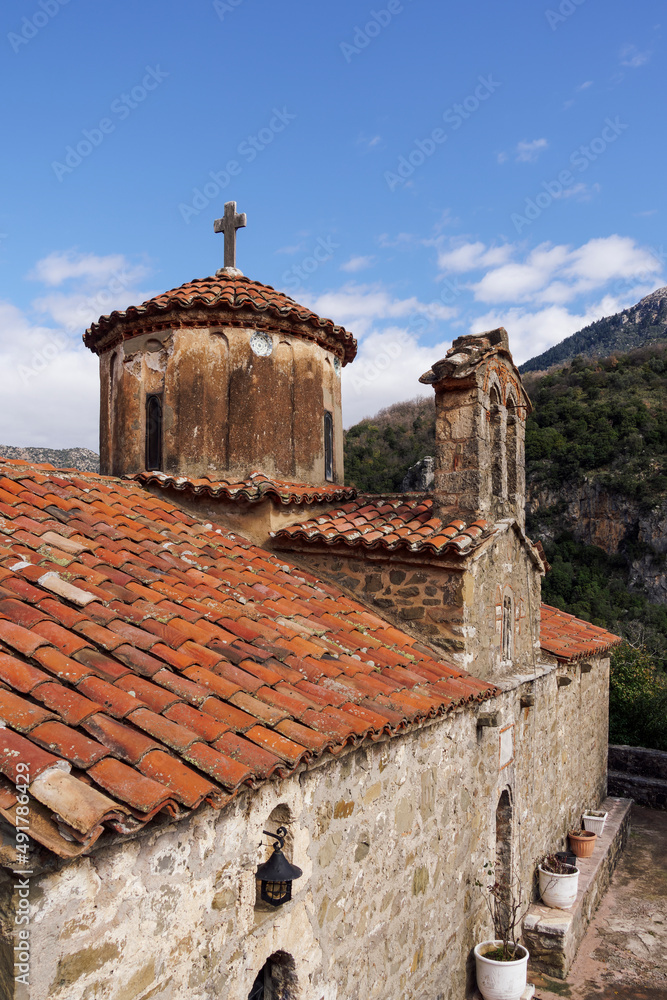 Greek Orthodox Monastery with cross above dome, against blue sky with ...