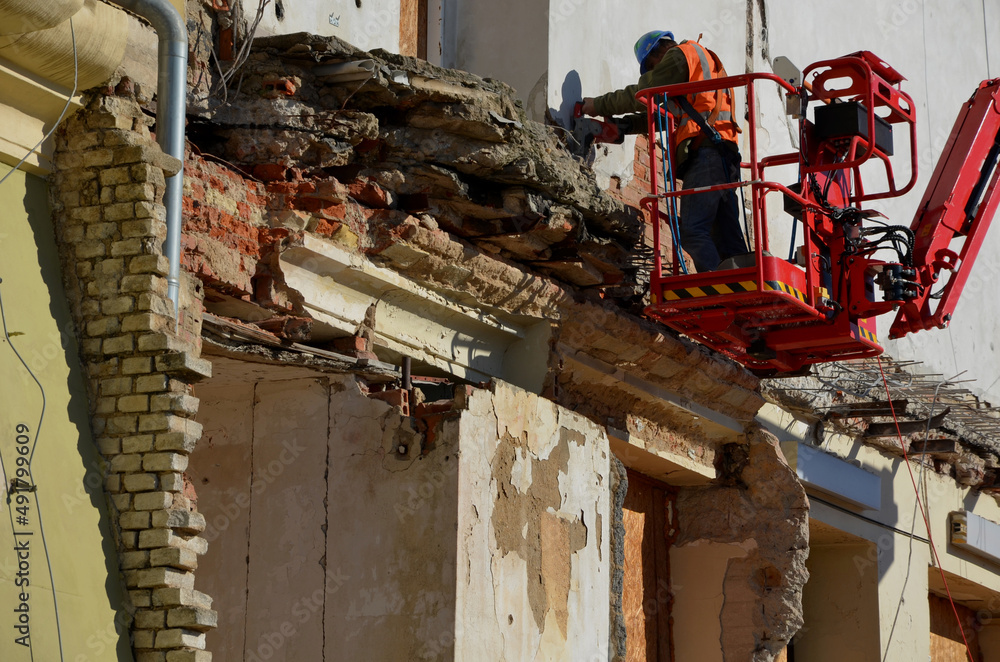 demolition of an apartment building worker on a forklift using a ...