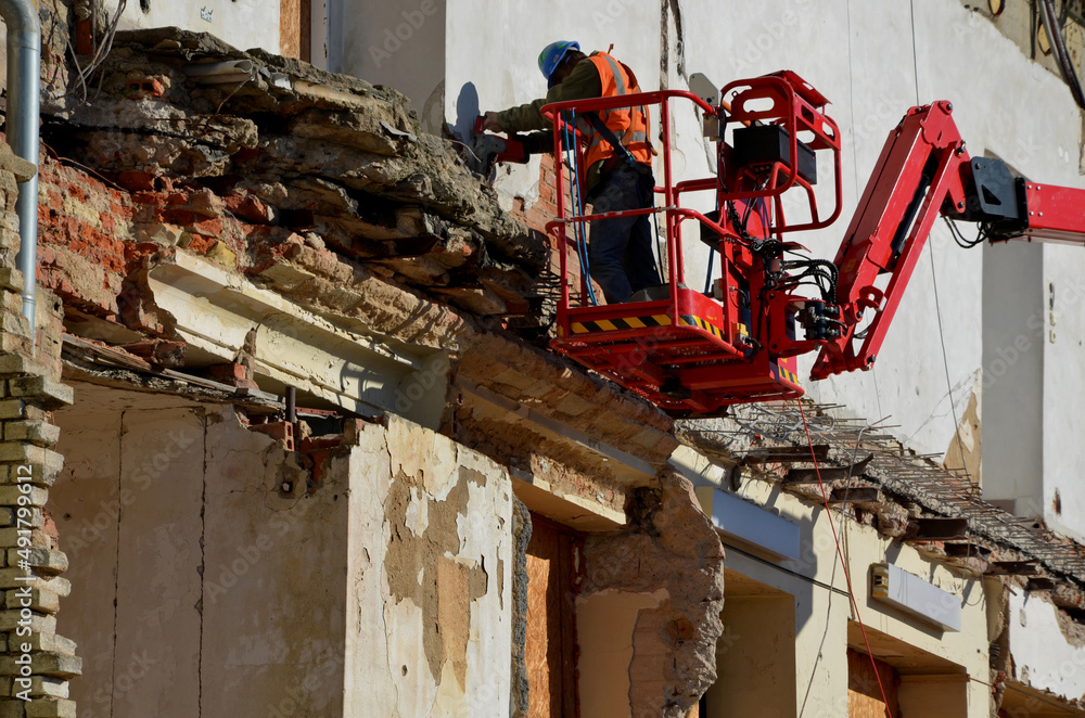 demolition of an apartment building worker on a forklift using a ...