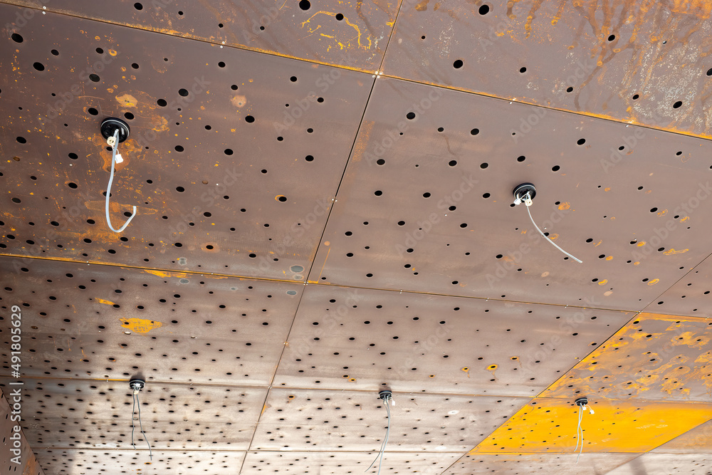 Installation of fire alarm sensors on the ceiling of the room ...