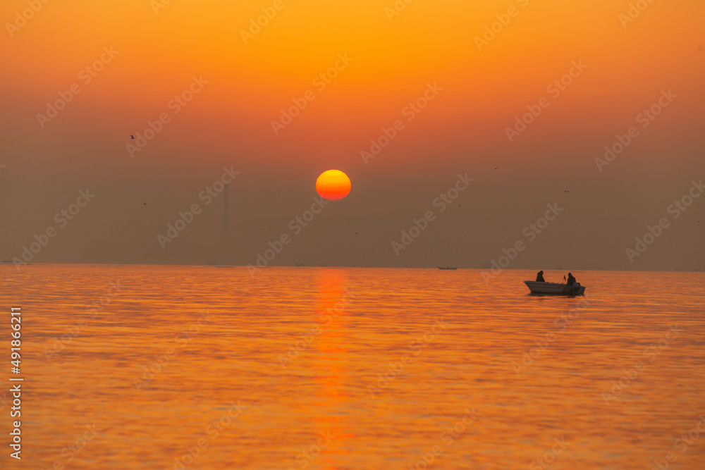 amazing colorful clouds on sunset. Beautiful golden sunset in the sea ...