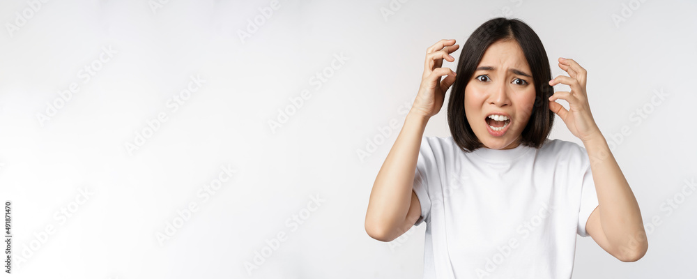 Korean woman freaking out, shaking hands and shouting in panic ...