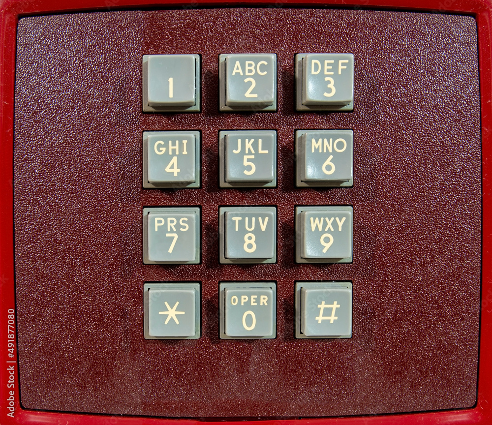 Old-fashioned push button red telephone keypad. Stock Photo | Adobe Stock