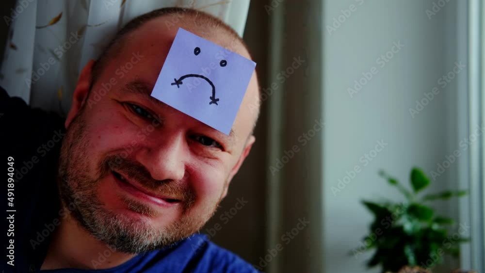 Sad man trying to smile with a sad smiley. Depression, burnout, midlife ...