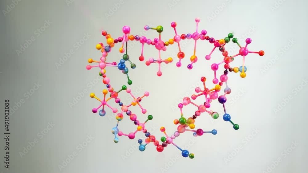 Colorful spheres balls like atoms..colors from atom of heart shape are ...