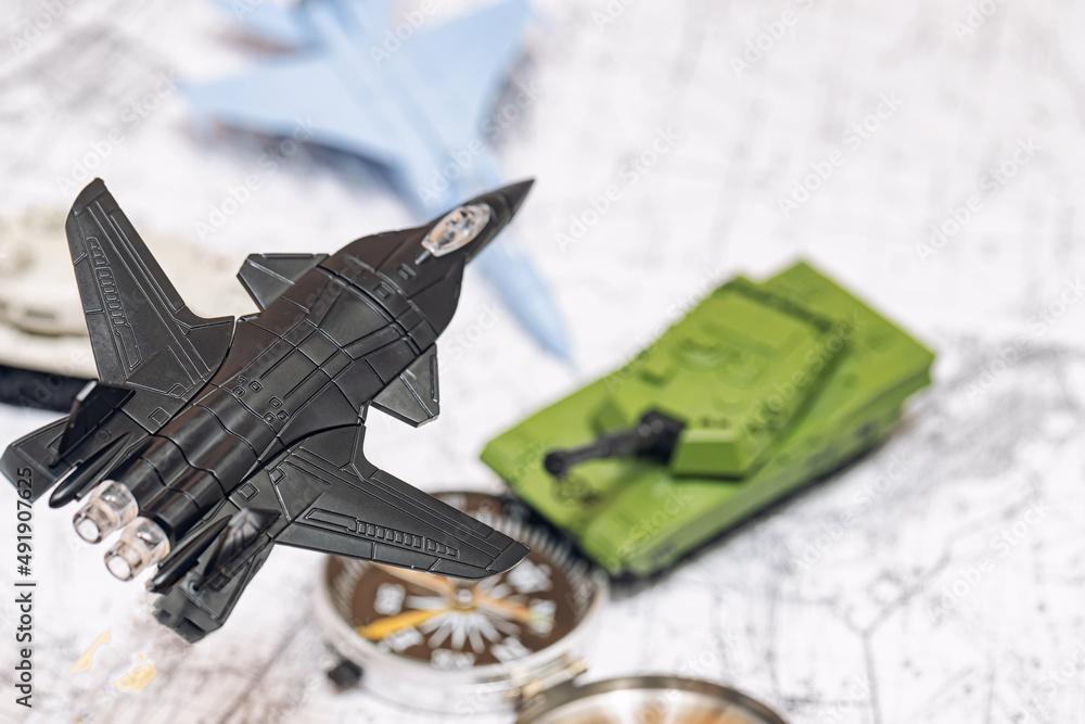 Planning a military operation on a map of the terrain using figures of ...