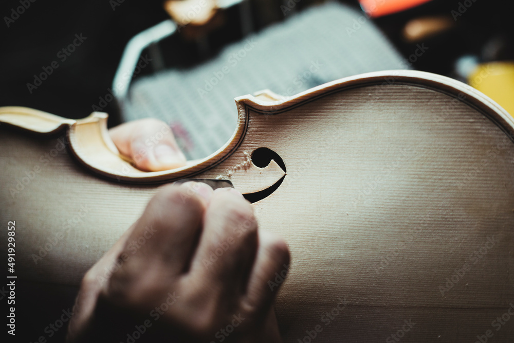 Unrecognized luthier creating a violin and using tools Stock Photo ...