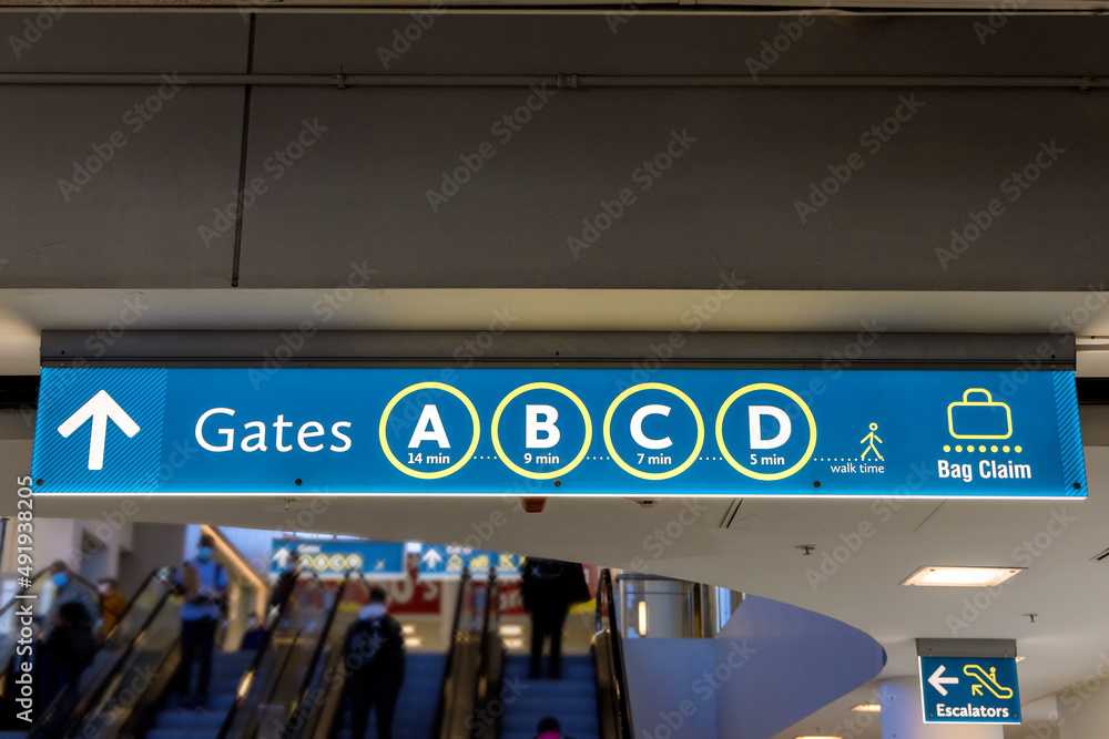 Airport sign board Gates A B C D Baggage Claim in air terminal Stock ...