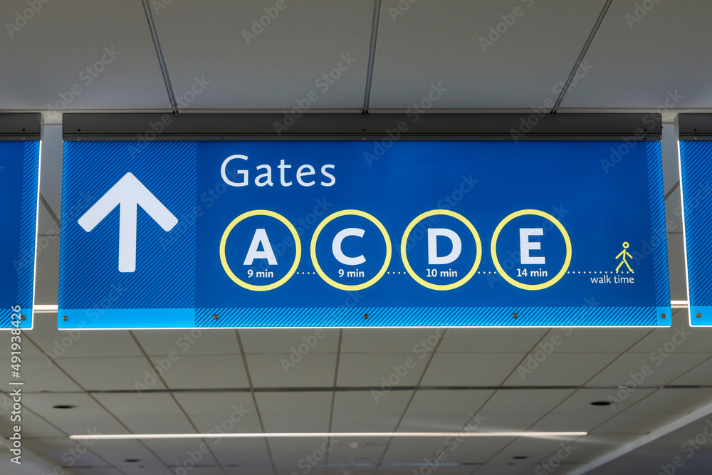 International Airport sign Gates A C D E in interior air terminal Stock ...
