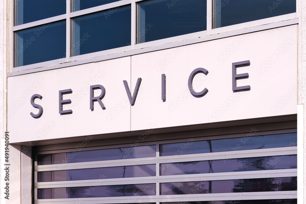 Service sign at car dealer building entrance with electrical operated ...