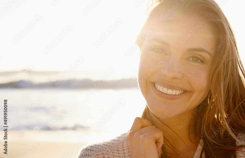 Stunning smile at sunset. A pretty young woman smiling confidently as ...