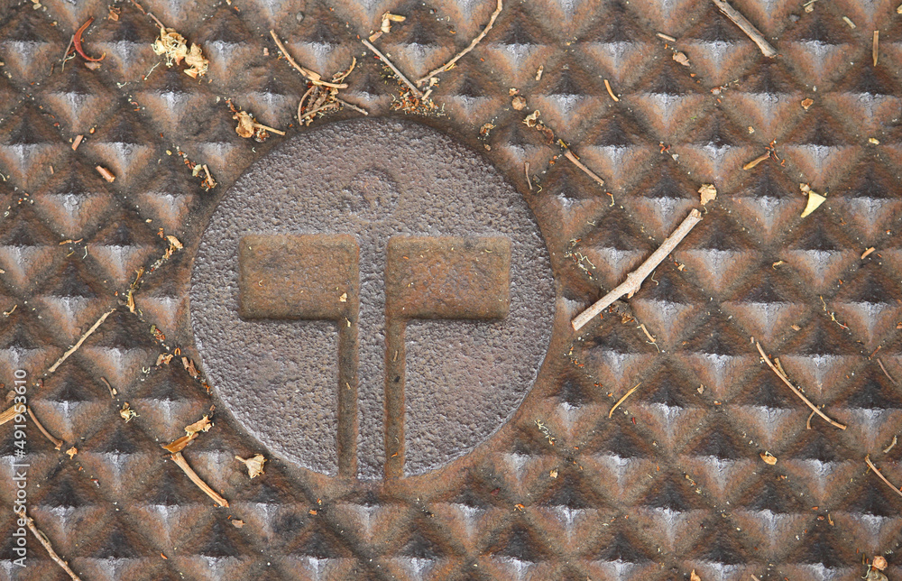 Telecommunication company's branded manhole cover. The cover is made ...