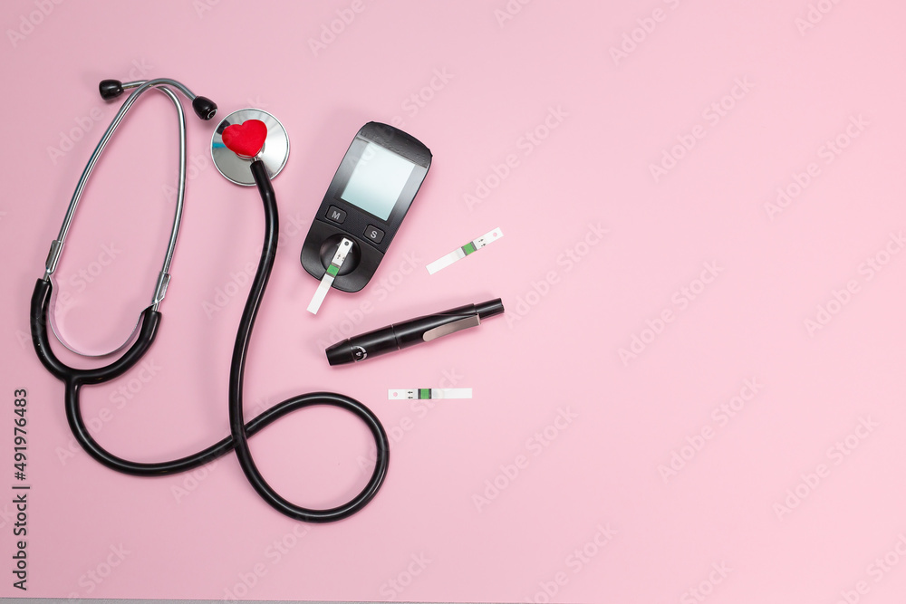 Diabetes equipment, glucose level blood test on pink background with ...