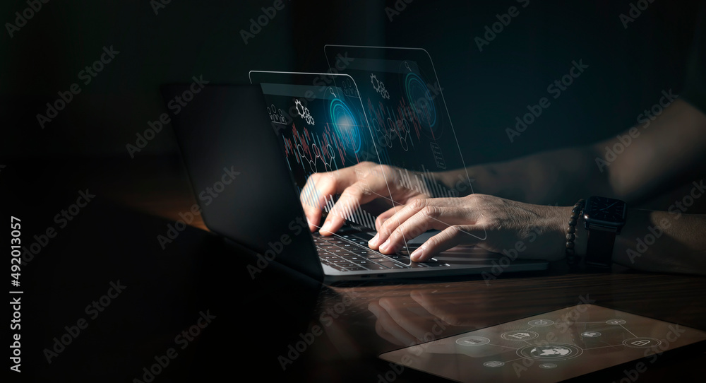 Foto de Businessman using laptop analyzing data and economic growth ...