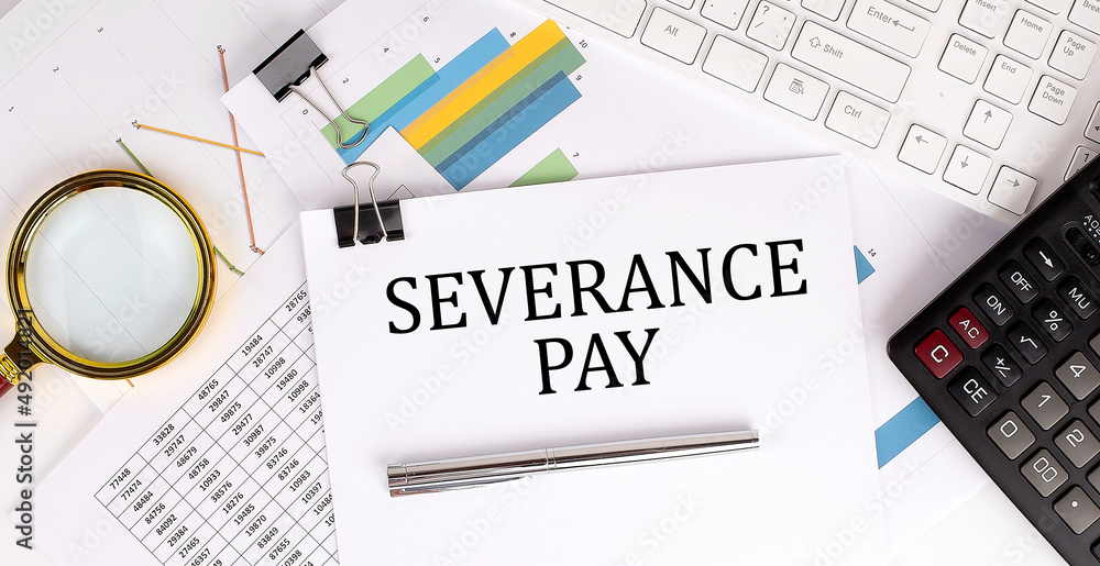 SEVERANCE PAY text on the white paper on the light background with ...