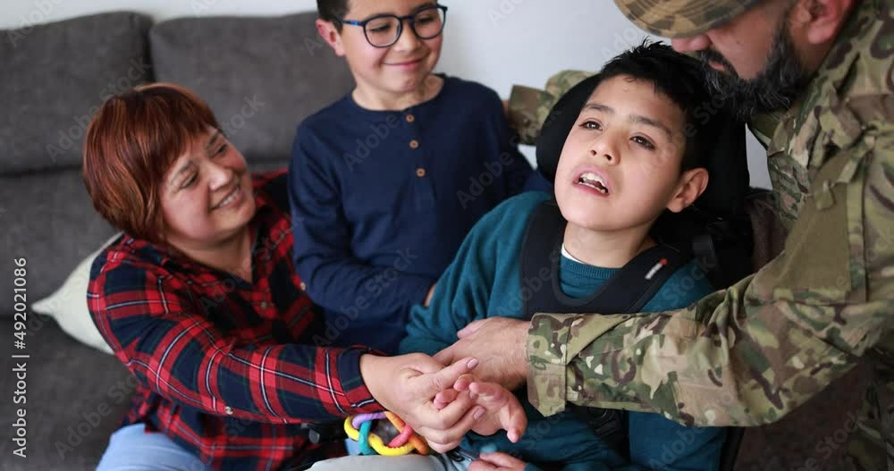 Happy veteran soldier man hugging his family after returning from ...
