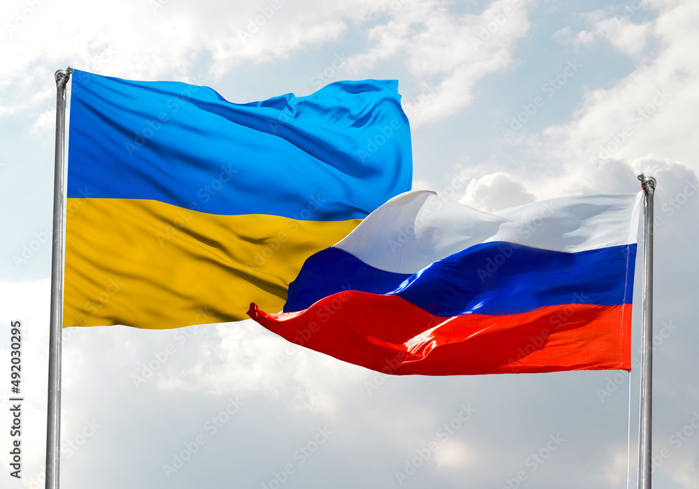 Ukraine Flag on Urss Russia Flag with clear sky in background Stock ...