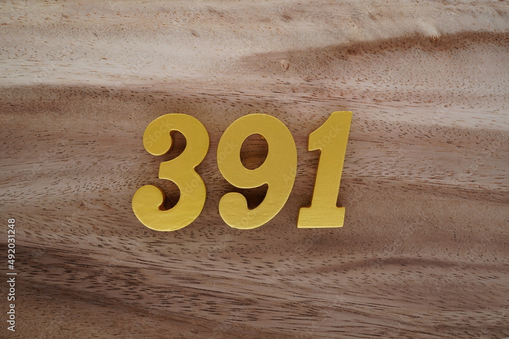 Golden Arabic numerals on a real brown and white wooden floor number ...