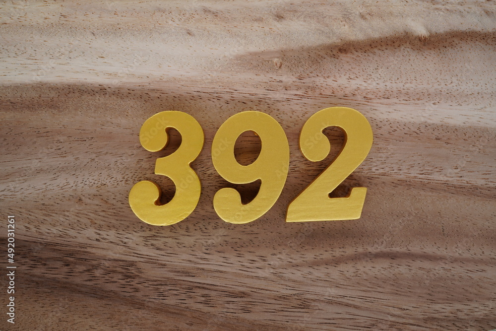 Golden Arabic numerals on a real brown and white wooden floor number ...