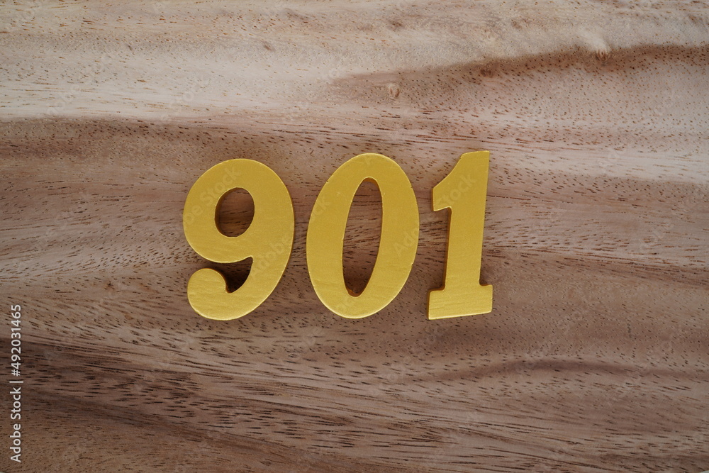 Golden Arabic numerals on a real brown and white wooden floor number ...