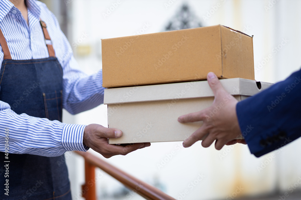 The courier is delivering the parcel to the recipient. The consignee ...