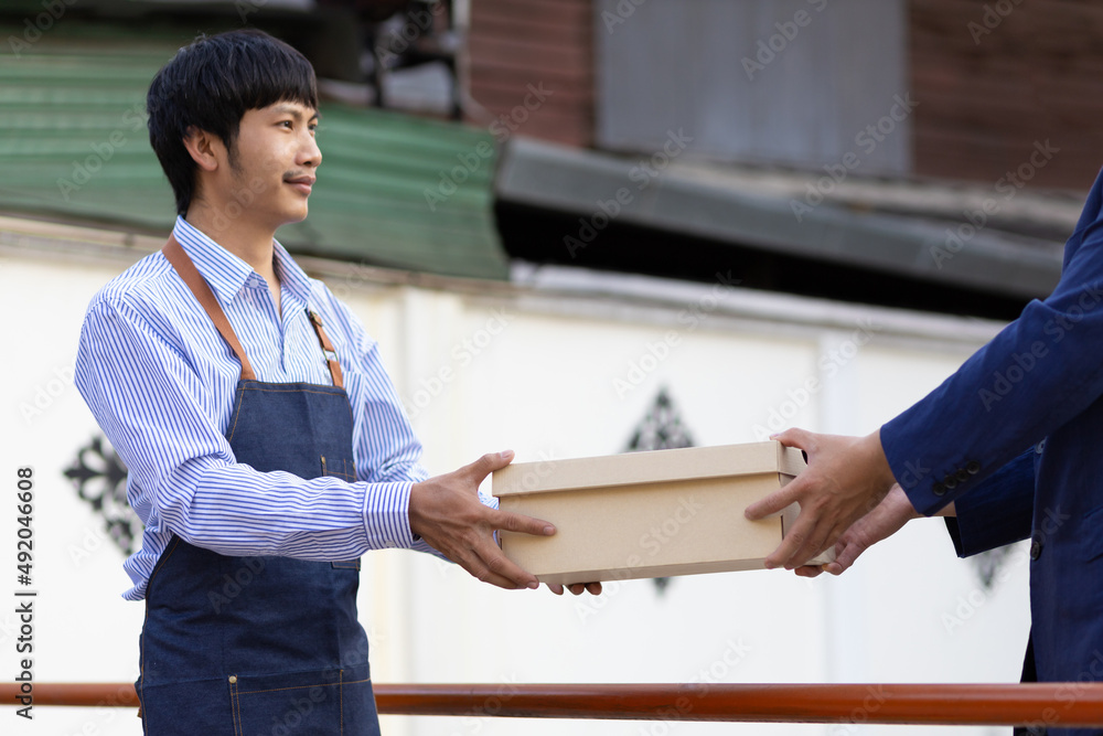 The courier is delivering the parcel to the recipient. The consignee ...