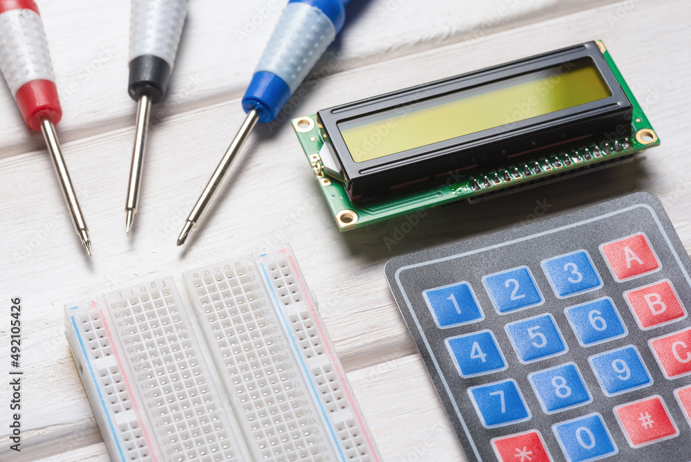Door access control keypad, breadboard and display on the white ...