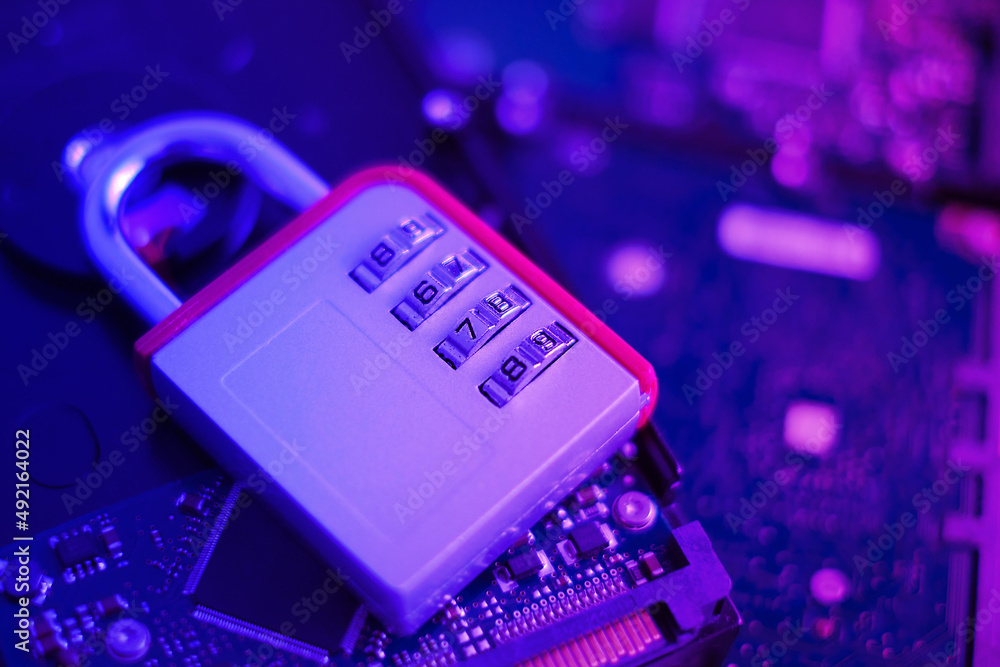 Encrypted hard disk. Padlock with cipher on an opened hard disk. Data ...