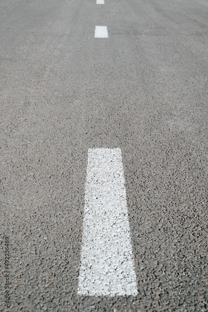 Vertical dividing white stripes on asphalt. Road marking line outdoors ...