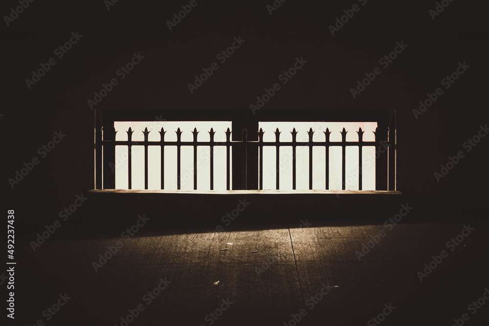 A dark New York street with a brightly lit window at night. Stock Photo ...