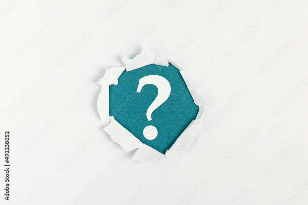 Question mark on paper background, search for answers, education ...