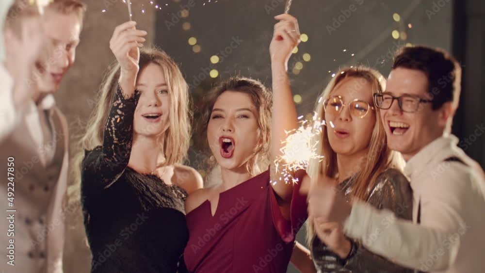 Asian girl and group young college student friends lit light sparkler ...