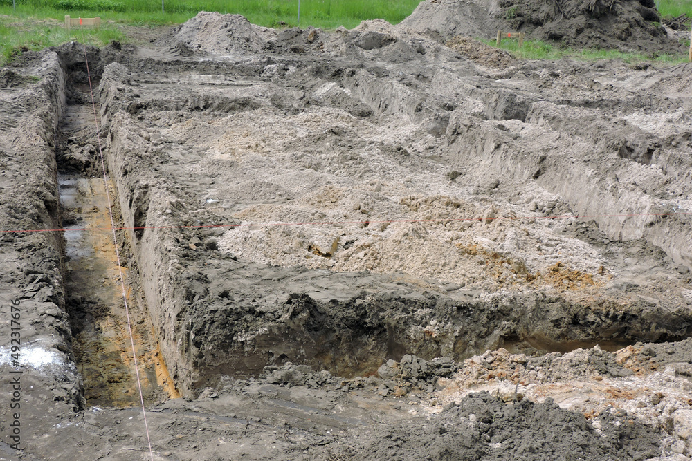 The deep excavation made for pouring concrete footing for a new house ...