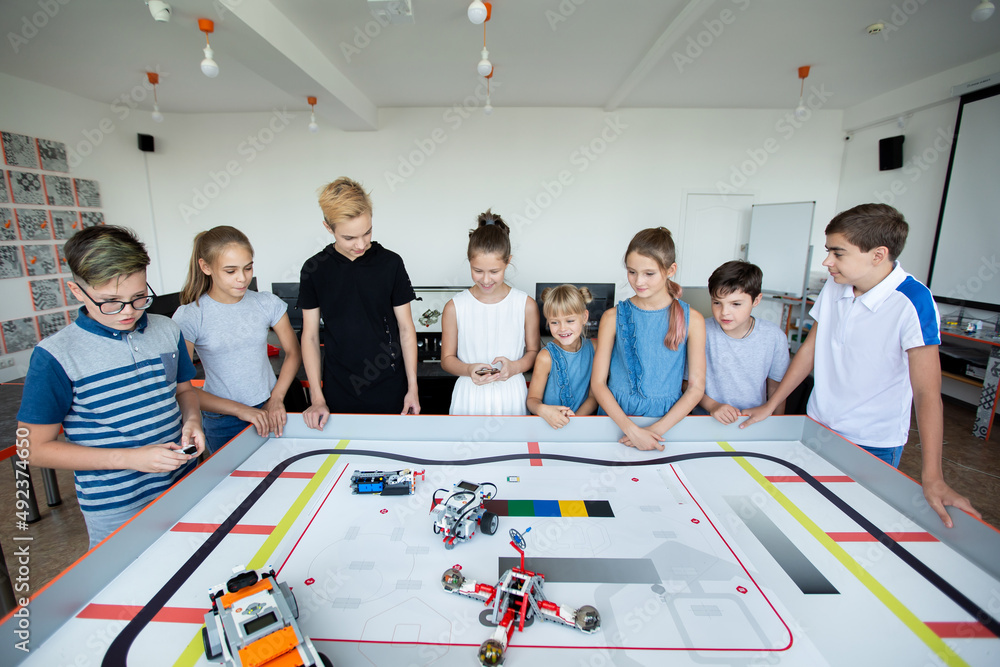 Robotics competitions. A group of children assembled robots from ...