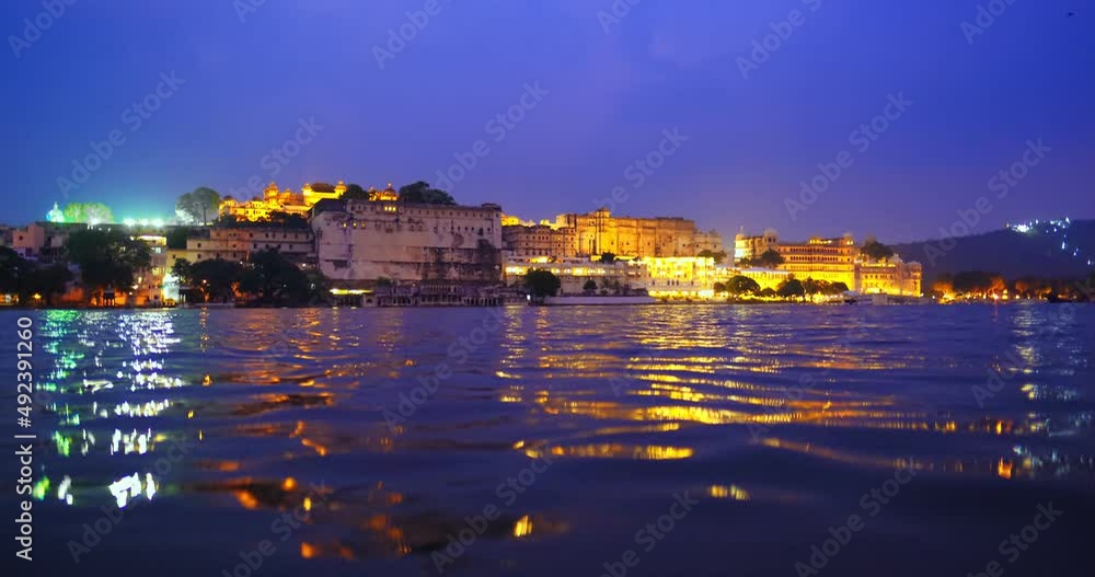 Udaipur City Palace on the bank of beautiful lake Pichola at sunset ...