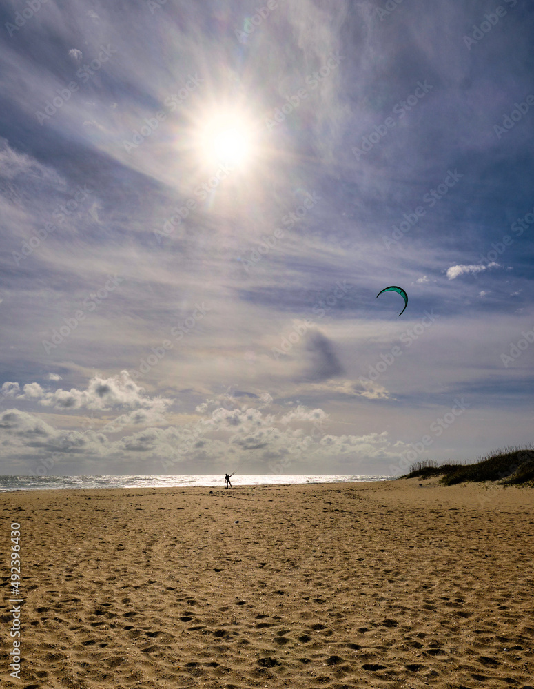 Vertical image of a parasailer on the beach on the Outer Banks of North ...