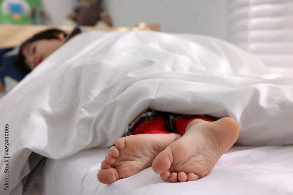 Little boy sleeping in bed at home, focus on feet Stock Photo | Adobe Stock