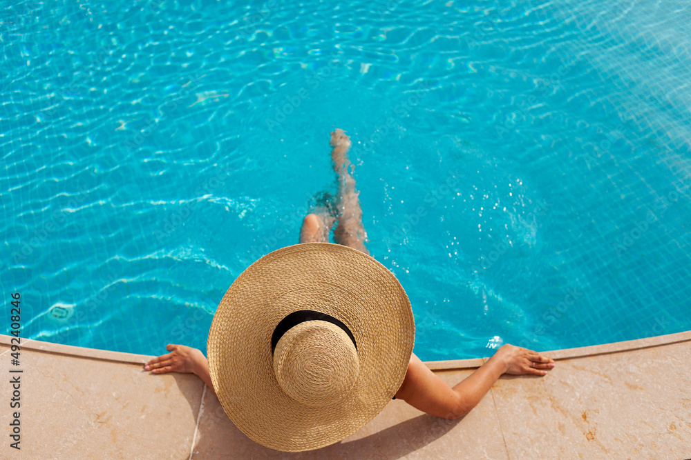 Beautiful woman sunbathing by the pool top view horizontal. Summer ...