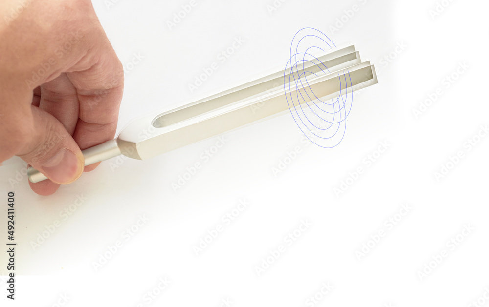Hand holds Tuning fork for ear test of ENT doctor or sound wave maker ...